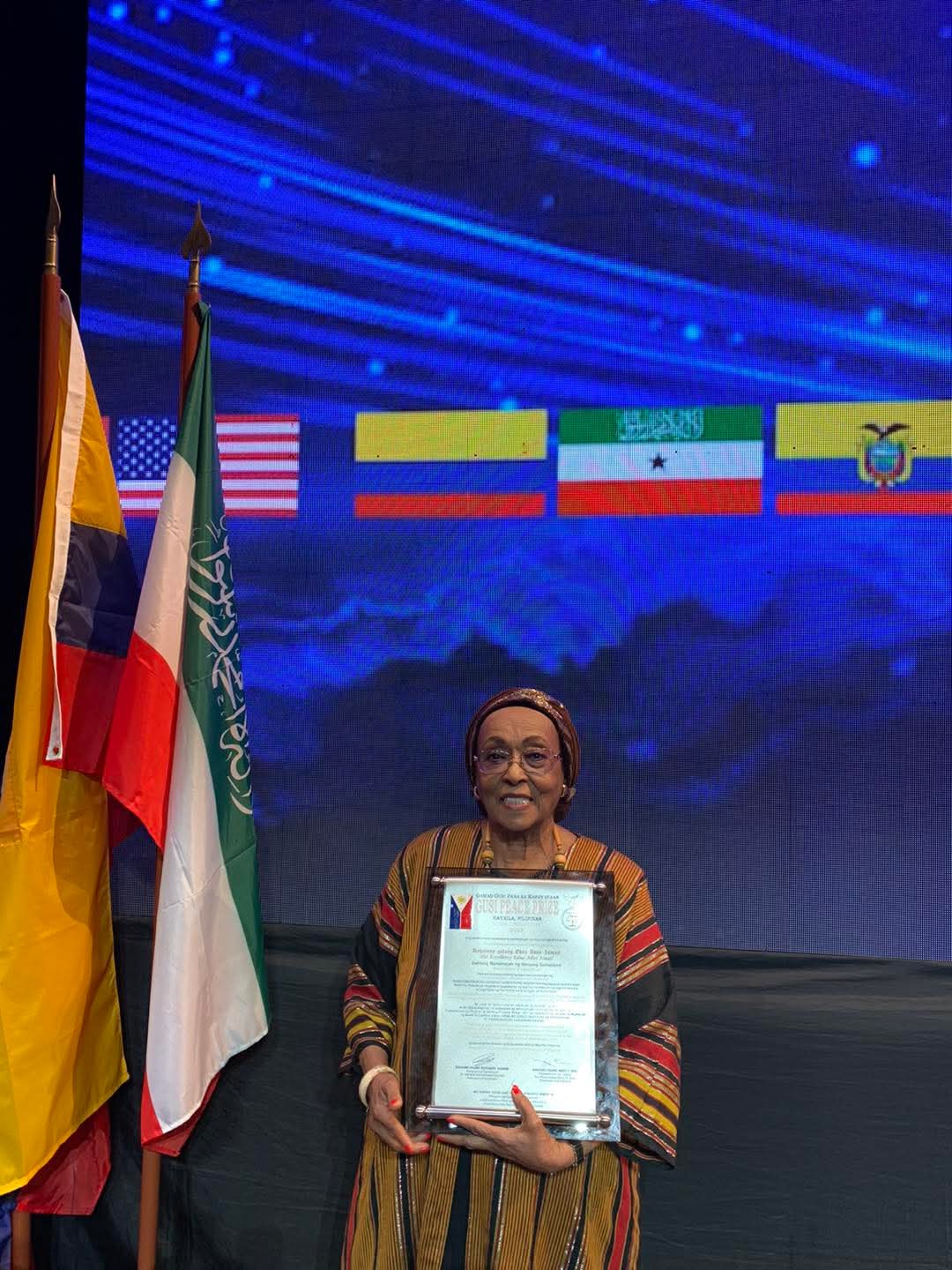 Dr. Edna Adan Ismail holding her Gusi Peace Prize International 2025 award.